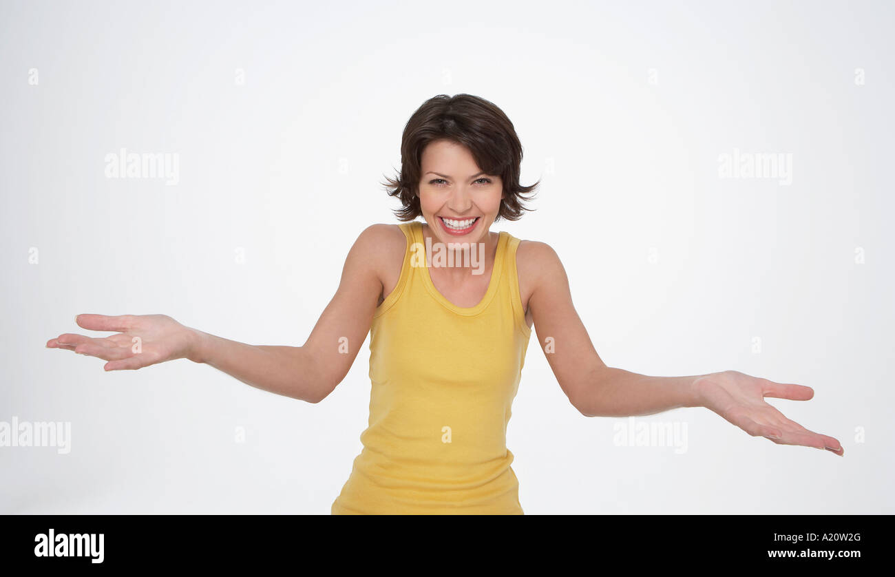 Enthusiastic woman smiling big, arms stretched out in front, palms up ...
