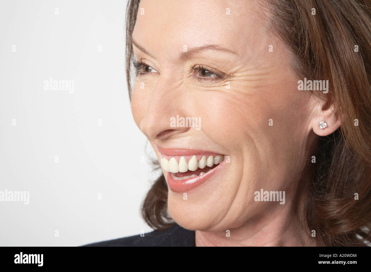 Middle-aged woman smiling big, side view, close-up Stock Photo - Alamy