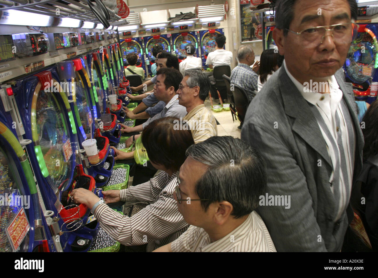 Japanese gamblers playing the popular Pachinko gambling machines in ...