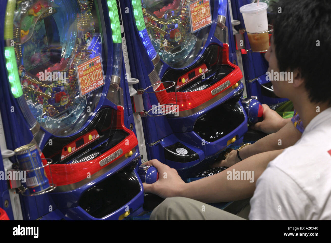 Japanese gamblers playing the popular Pachinko gambling machines in ...