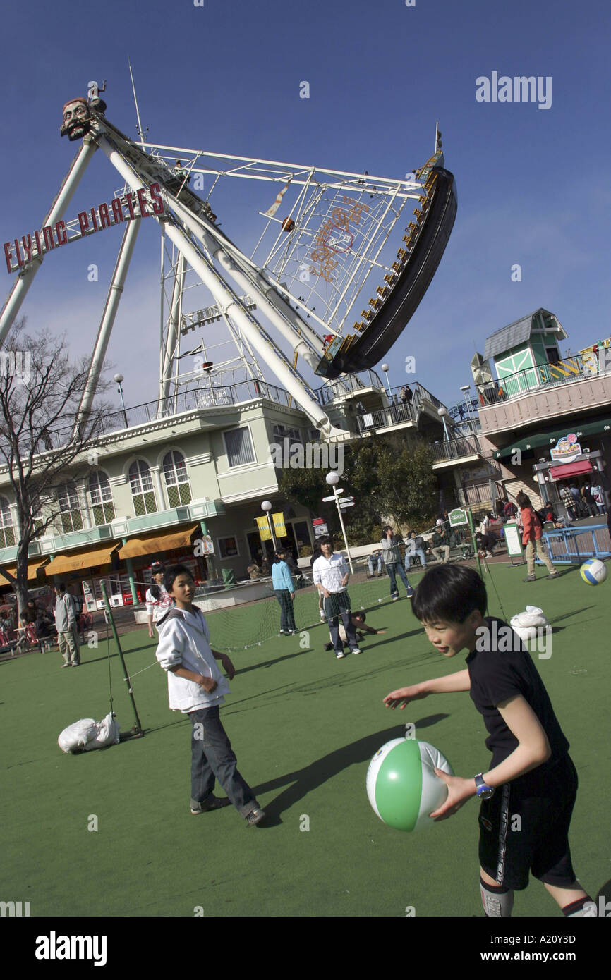 Children playing in front of the The Flying Pirates ride in the ...