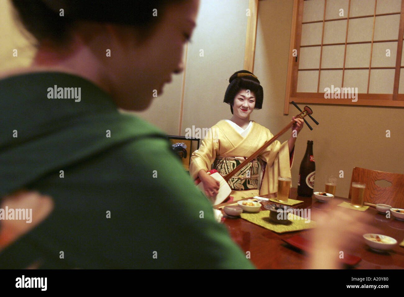 'Yachiho' a geisha girl plays the shamisen musical instrument at a tea ...