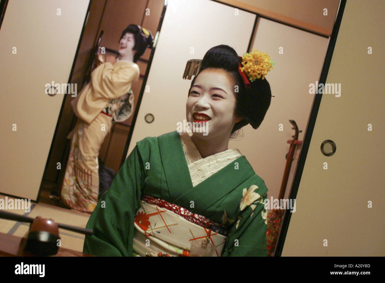 Geisha and maiko girl at a tea house in the Geisha district of ...