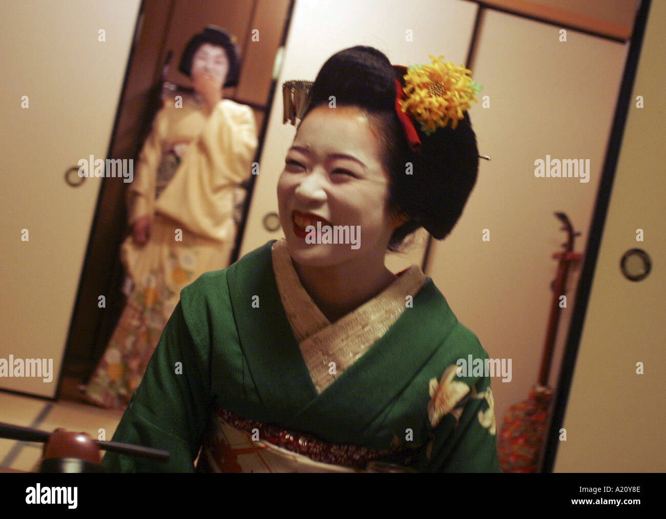 Geisha and maiko girl at a tea house in the Geisha district of ...