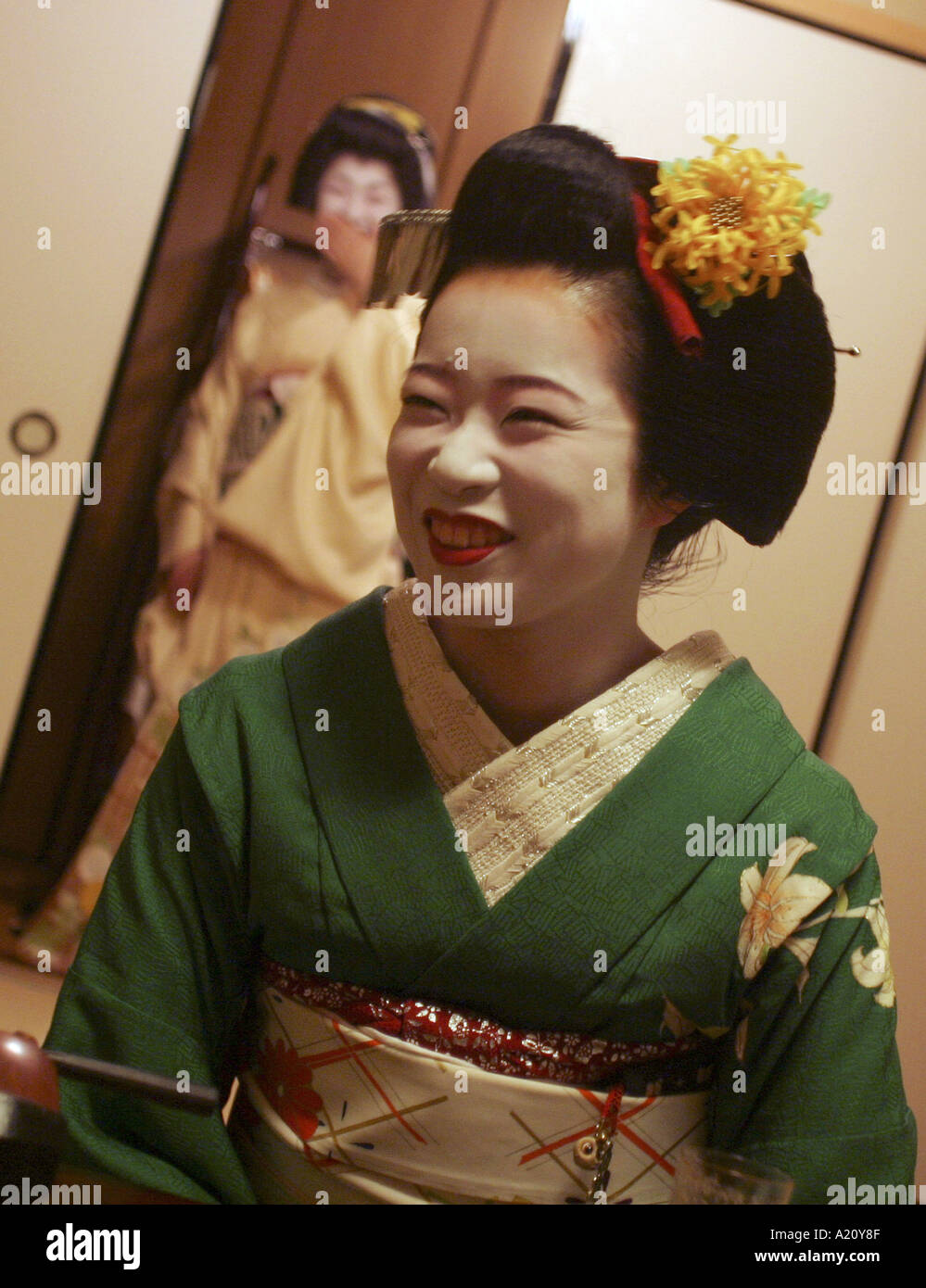 Geisha and maiko girl at a tea house in the Geisha district of ...