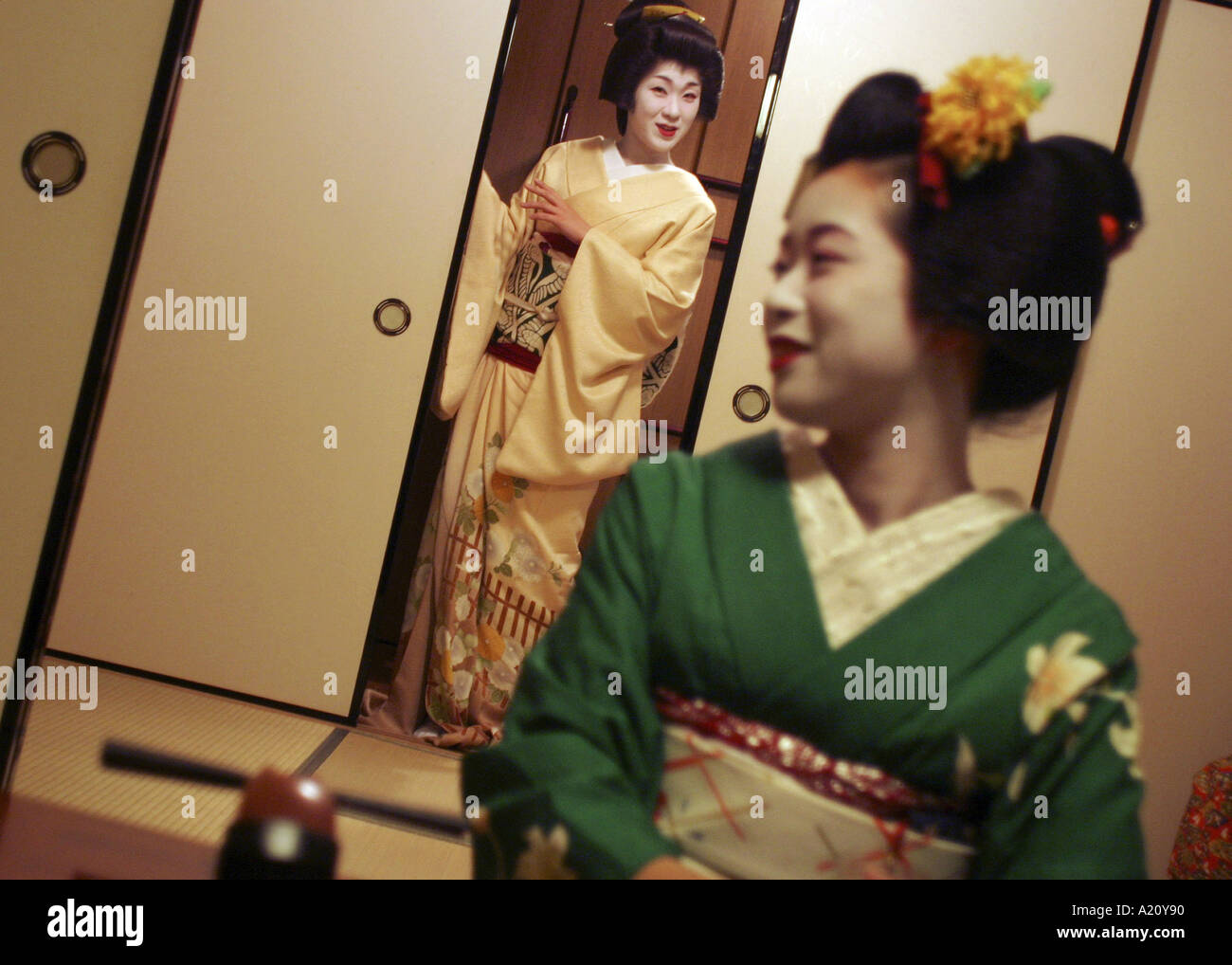 Geisha and maiko girl at a tea house in the Geisha district of ...