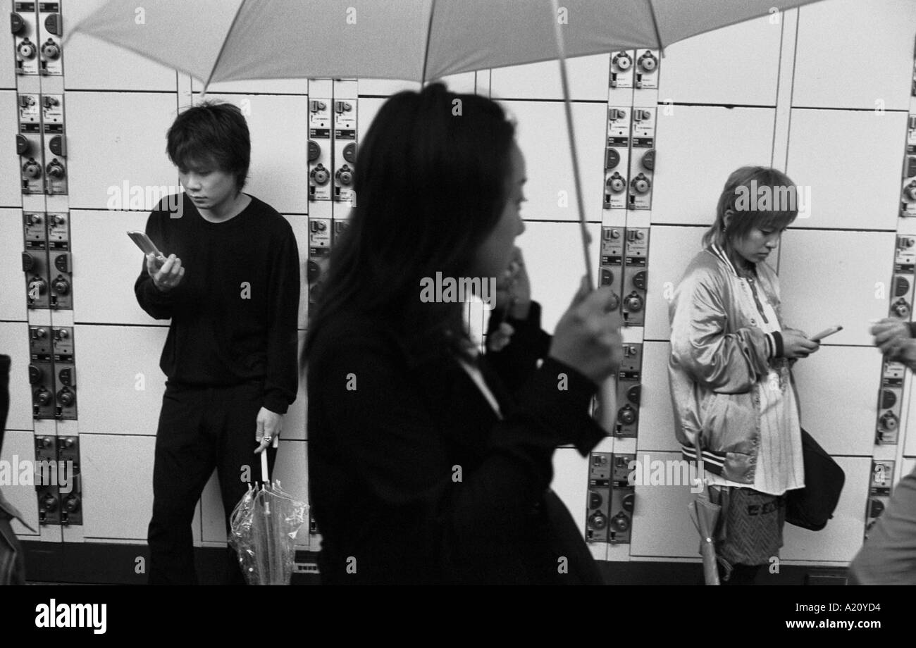 Japanese people using their telephones for text messaging, Shibuya ...