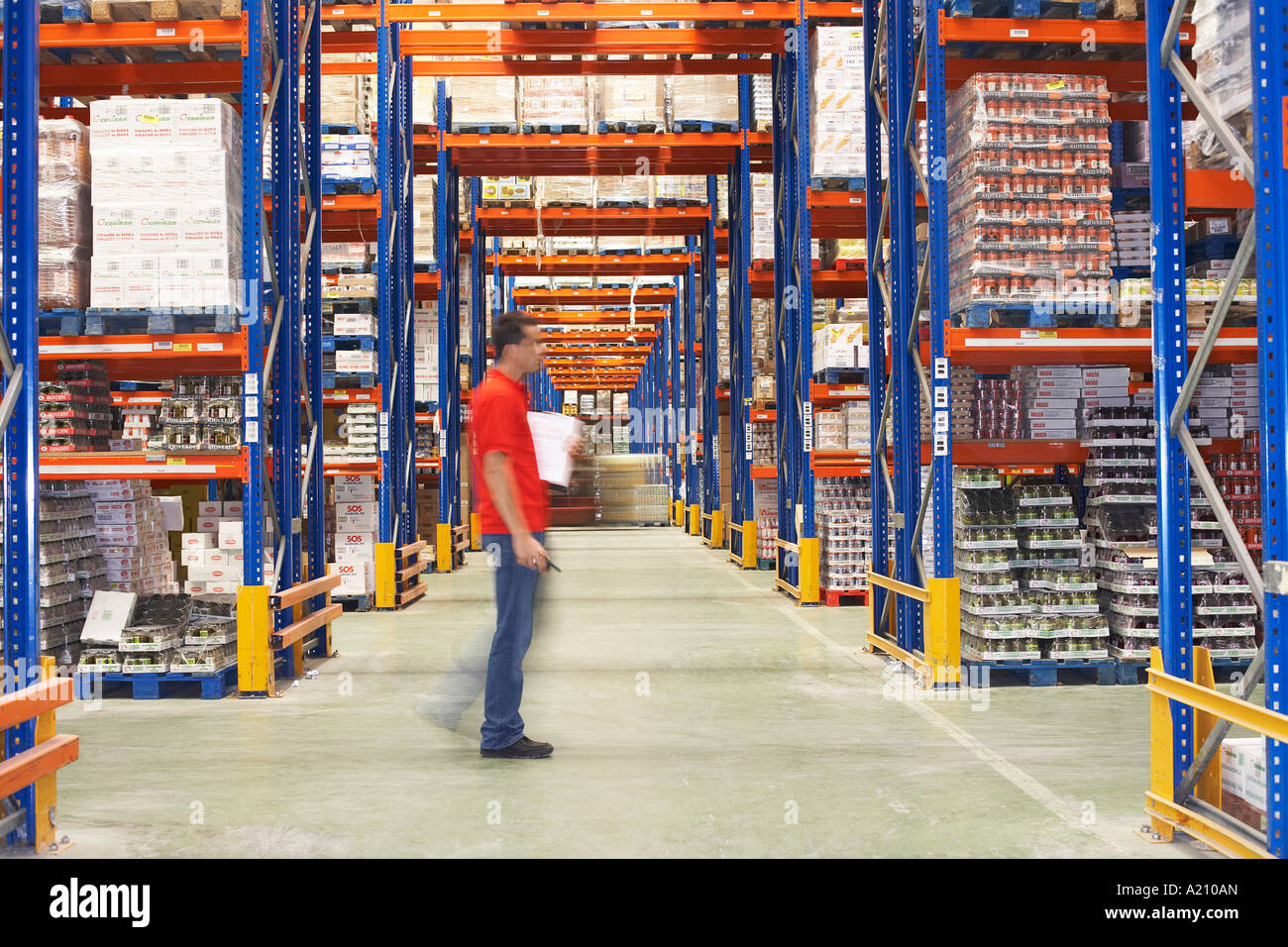Man Walking Through Warehouse, side view Stock Photo - Alamy