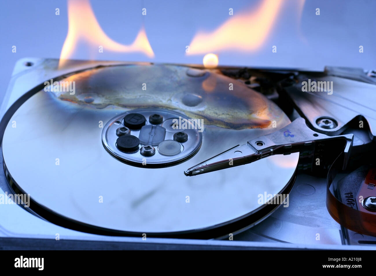 A computer hard disk on fire. Concept of data loss or data destruction ...