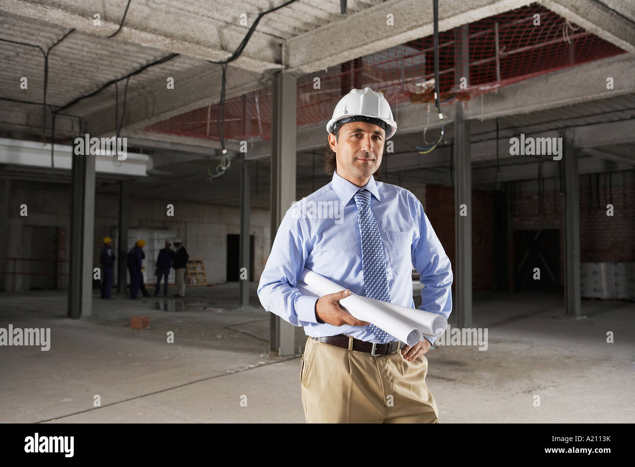 Manager posing holding helmet hi-res stock photography and images - Alamy
