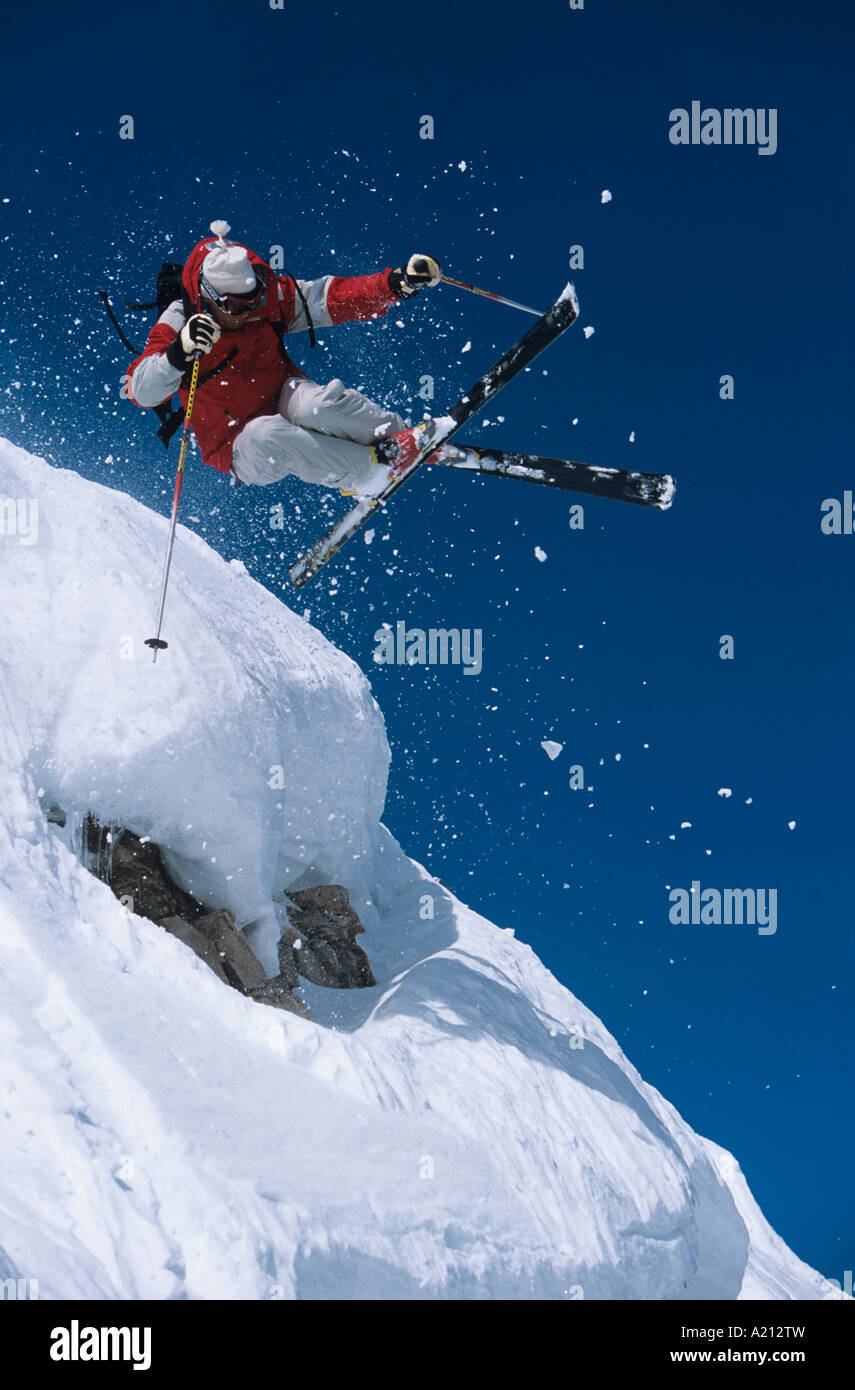 Skier in mid-air above snow on ski Slopes Stock Photo - Alamy