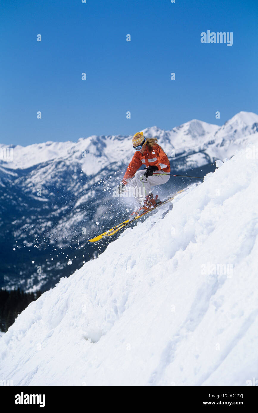Skier skiing down ski slope, side view Stock Photo - Alamy