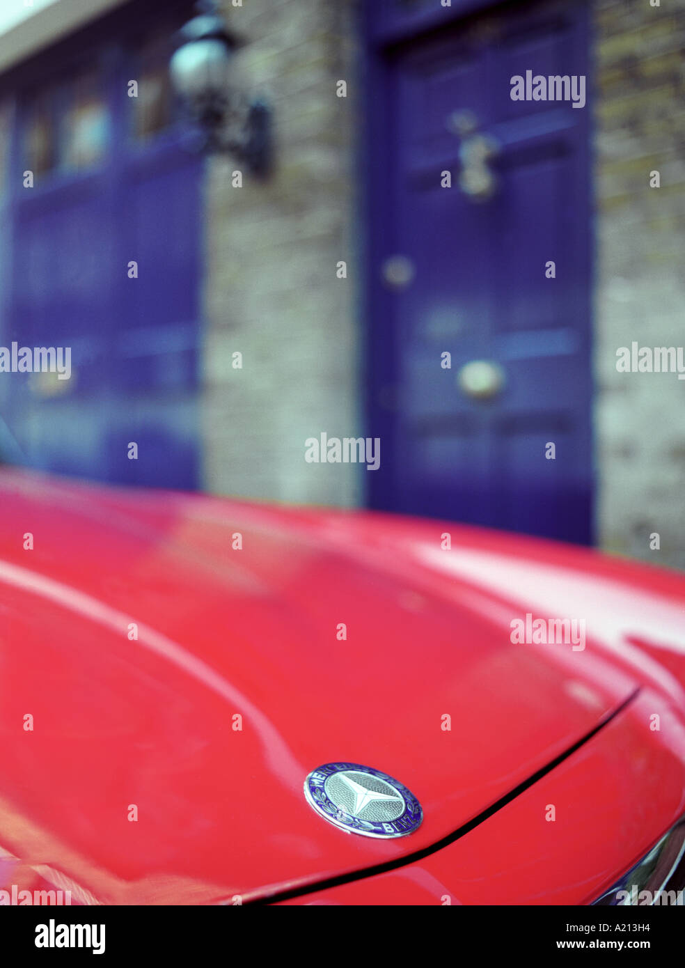 detail of red mercedes car parked outside an expensive urban mews ...
