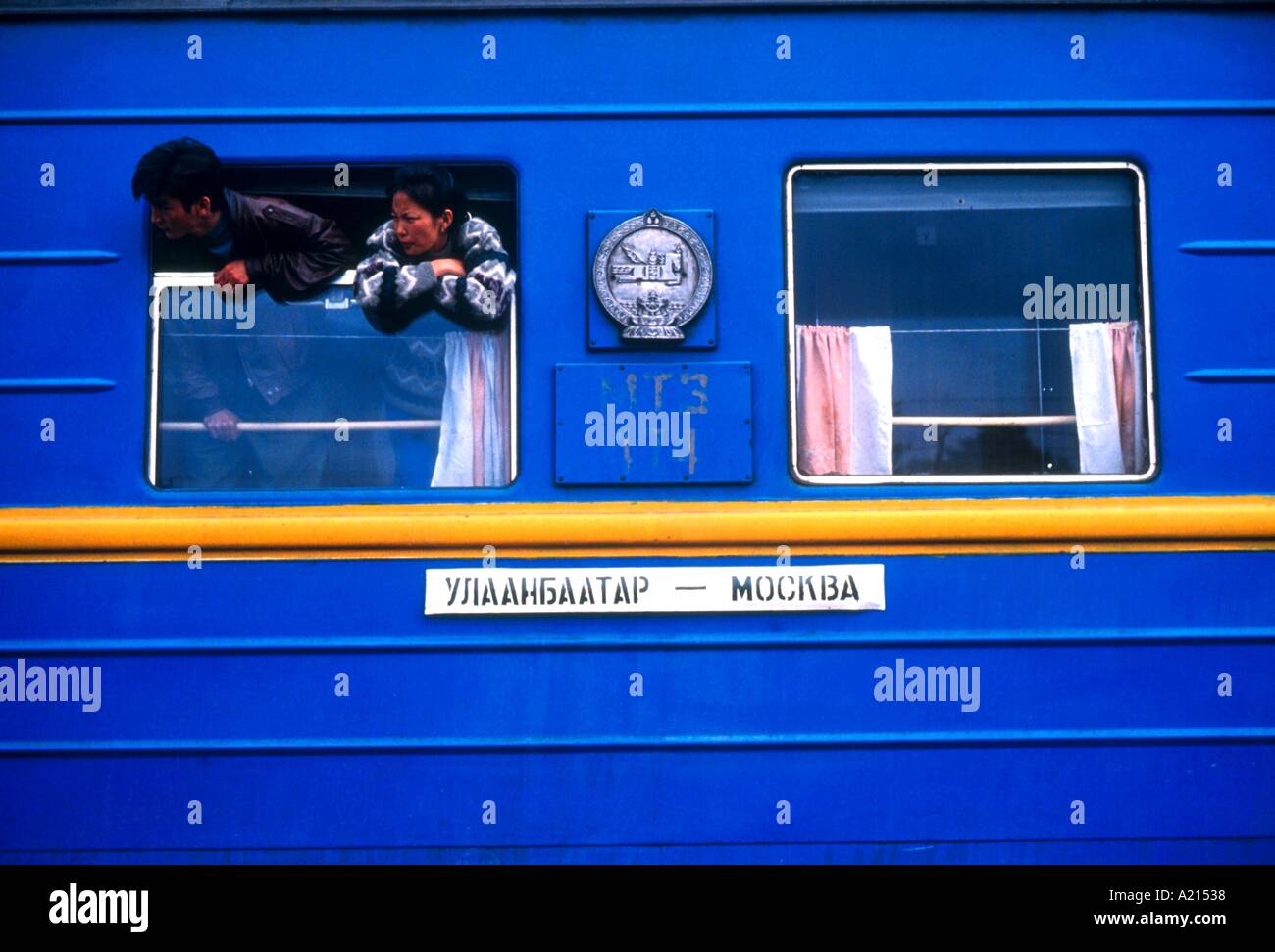 Two people hanging out of carriage window on Moscow to Vladivostok ...