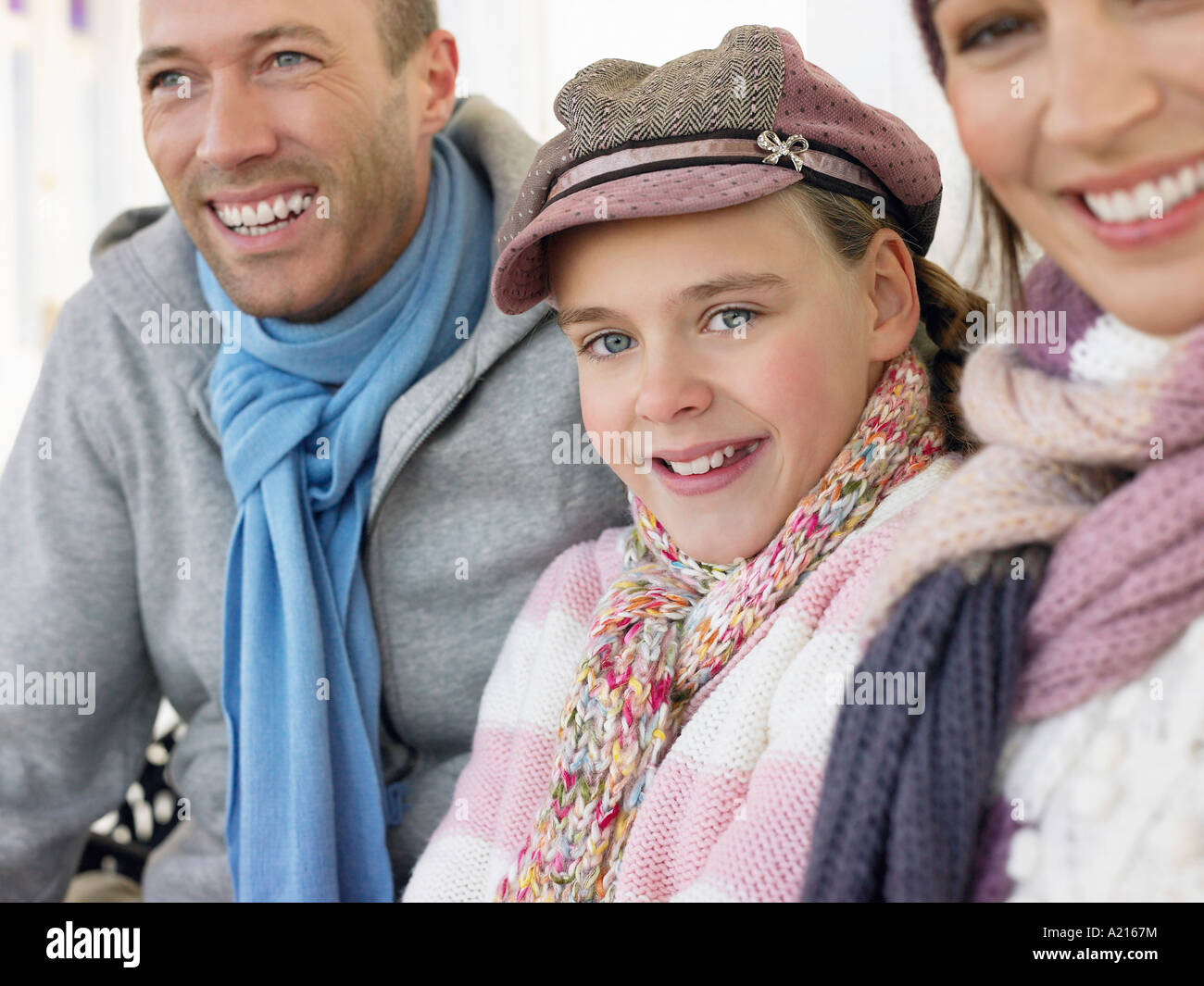 Family of three sitting side by side on bench, portrait, close up Stock ...