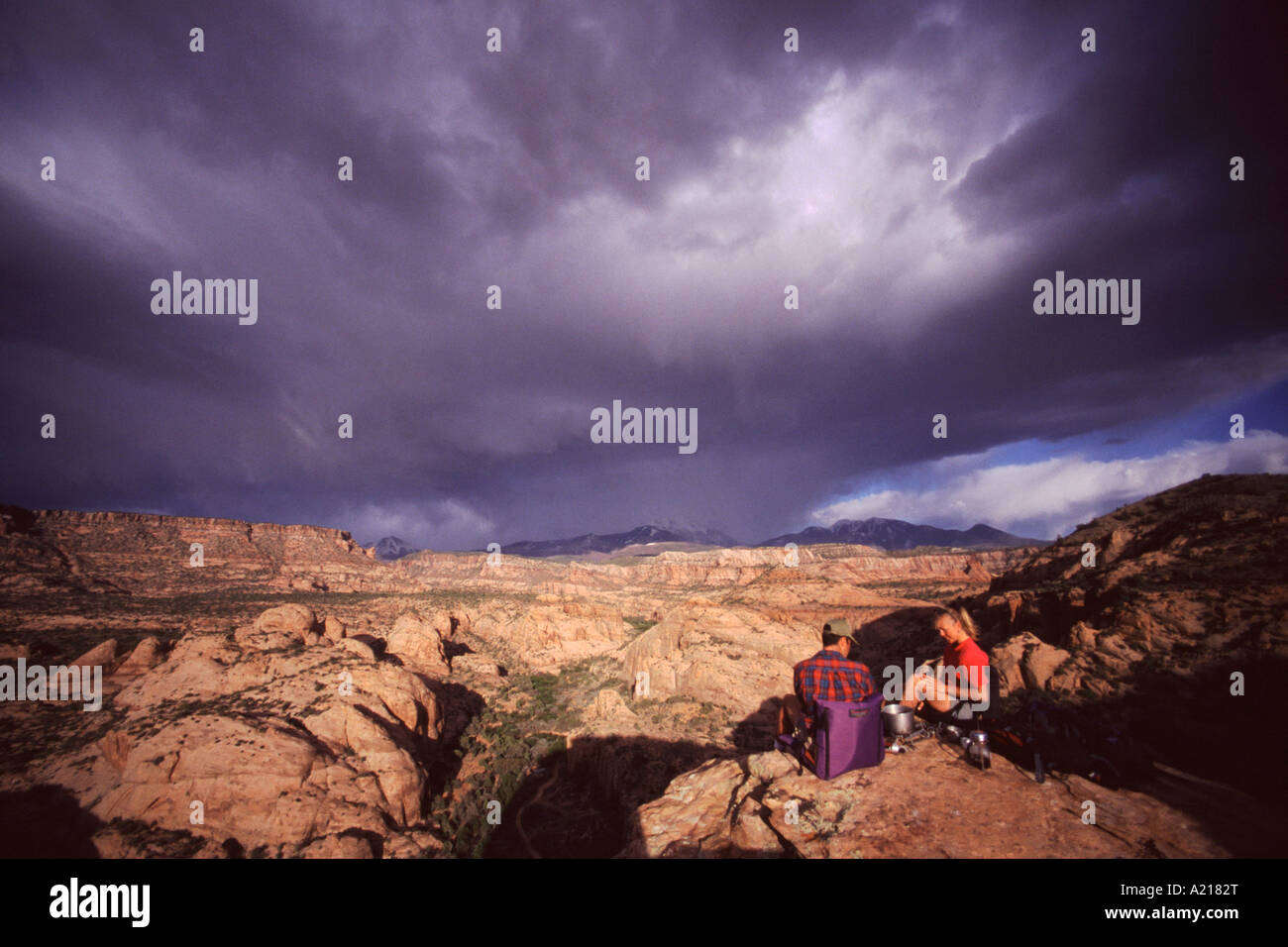 Two People Camping Beneath Storm Clouds Near Moab Utah Stock Photo - Alamy