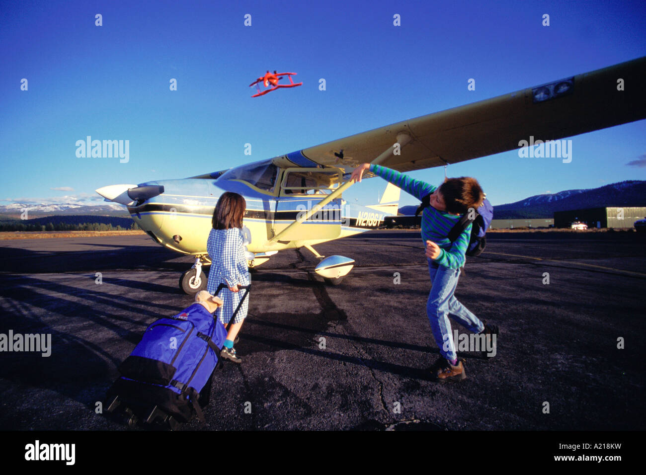 Two kids boarding a small airplane in Truckee California Stock Photo ...