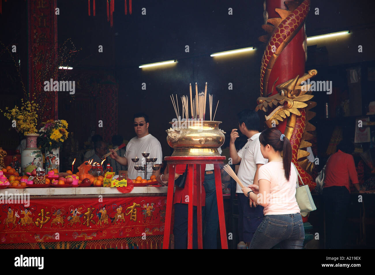 Chinese man praying at temple Stock Photo - Alamy