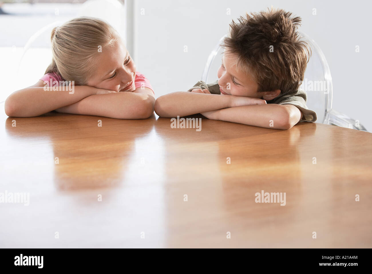 Child sitting table arms crossed hi-res stock photography and images ...