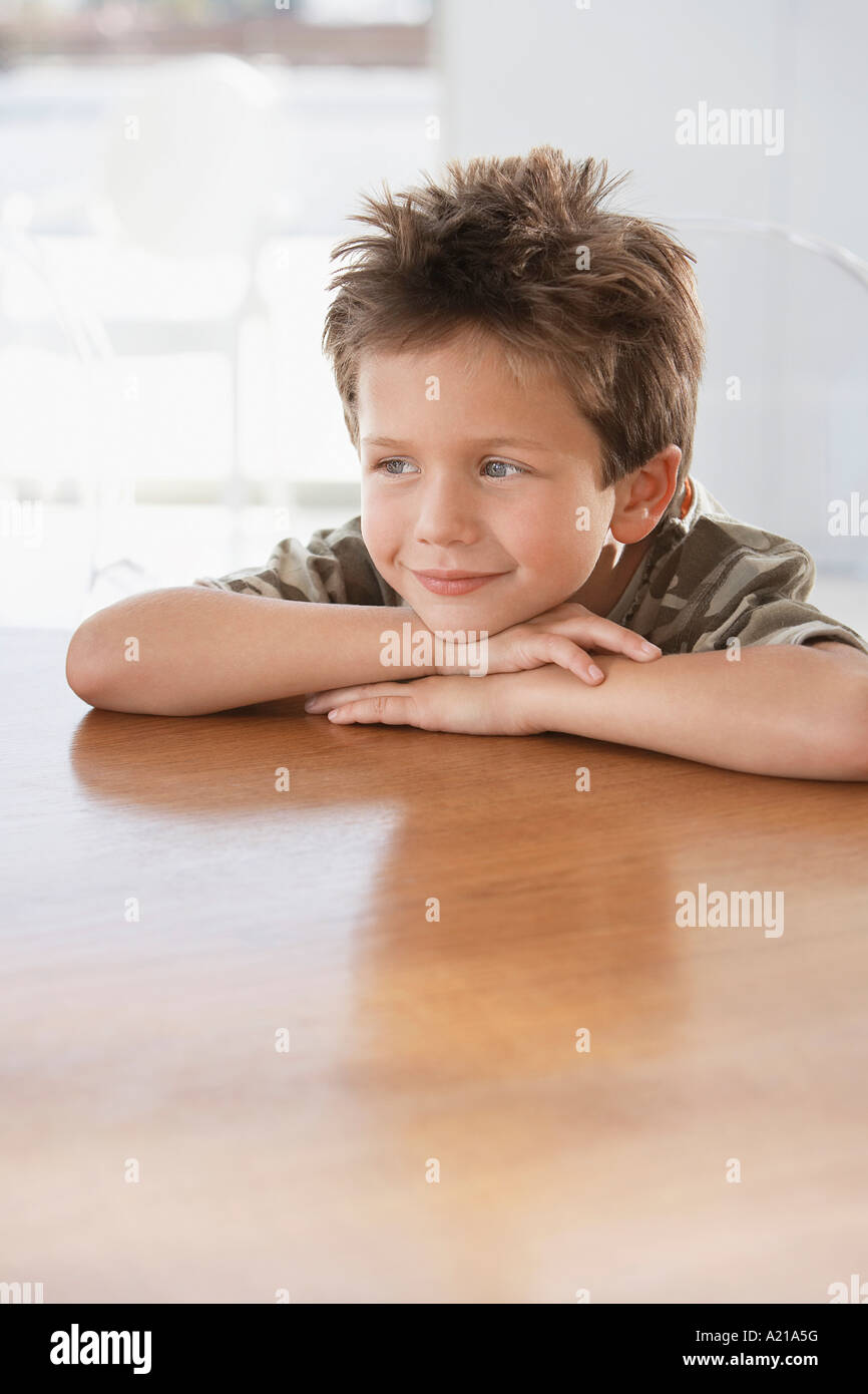 Young Boy with His Head on hands, resting on the Table Stock Photo - Alamy
