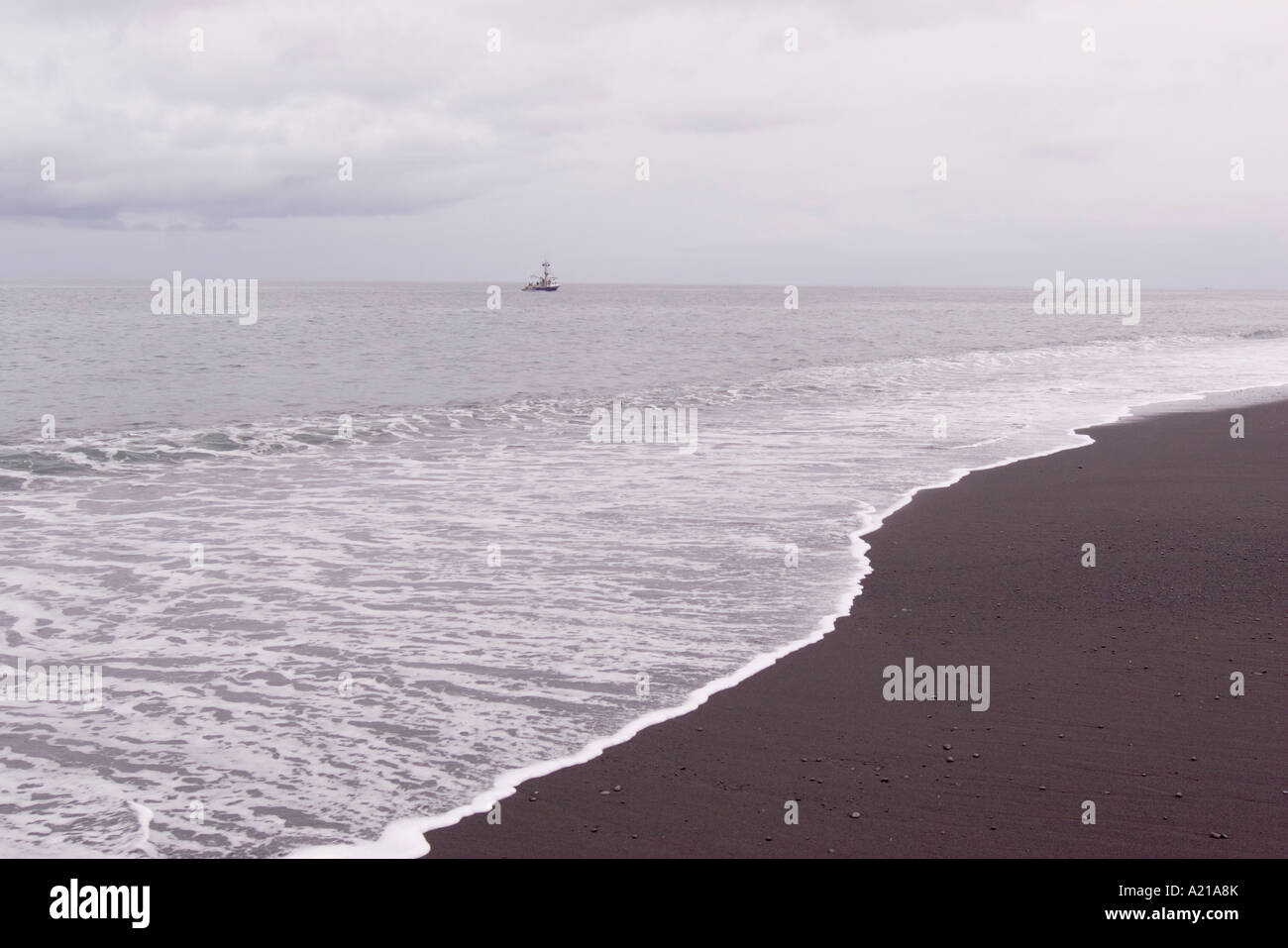 Boat in the distance as seen form the shore on an Aleutian Island Stock ...