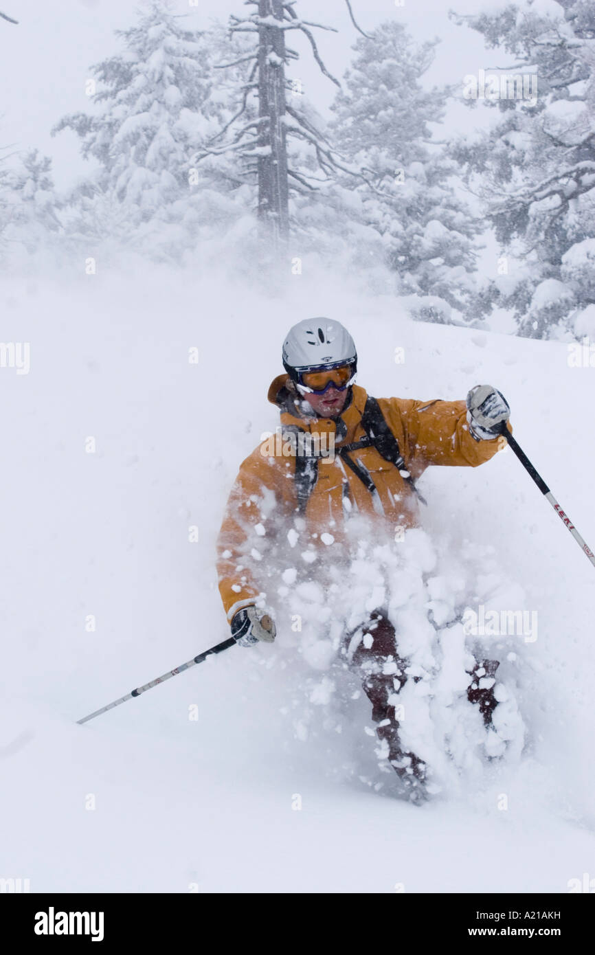 A man skiing deep powder snow in a storm Alpine Meadows in Lake Tahoe ...