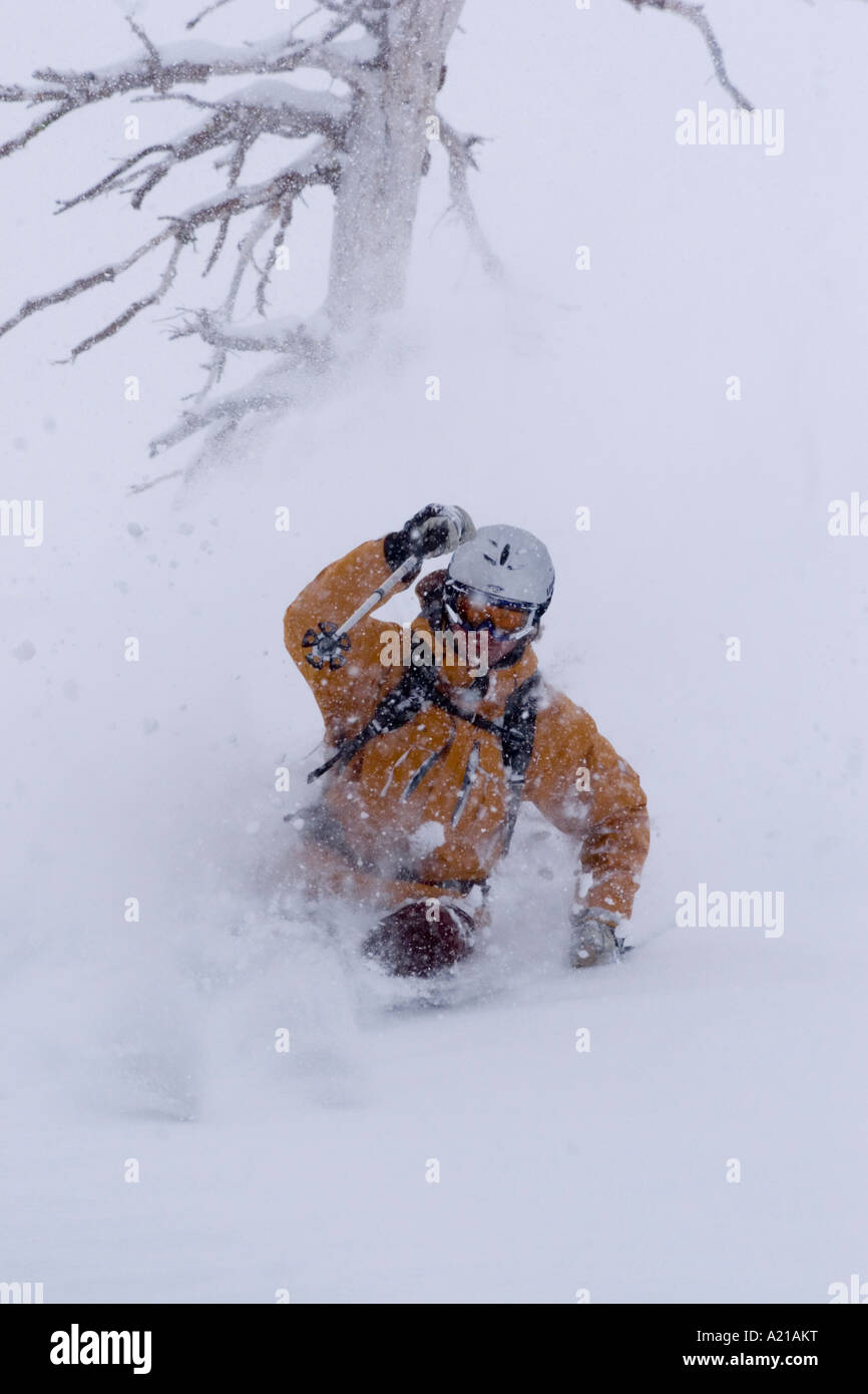 A man skiing deep powder snow in a storm Alpine Meadows in Lake Tahoe ...