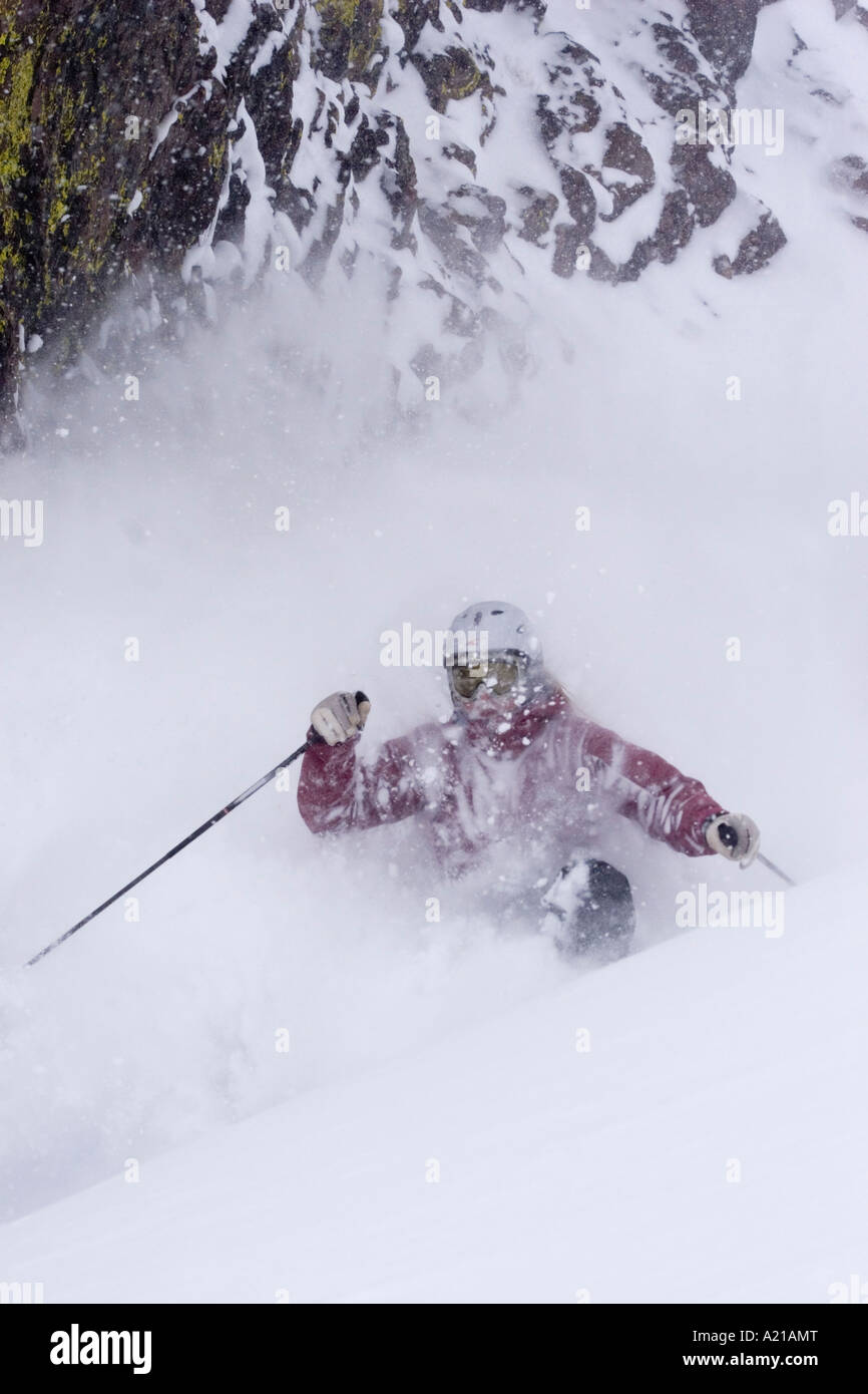 A woman skiing deep powder snow in a storm Alpine Meadows in Lake Tahoe ...