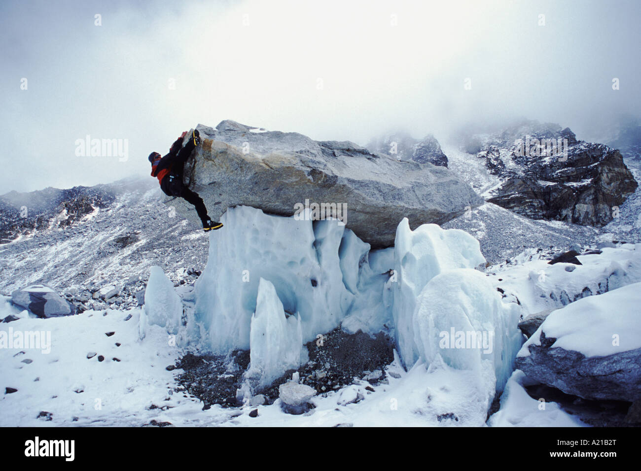 A climber in Everest basecamp ascending a rock in Nepal Stock Photo - Alamy