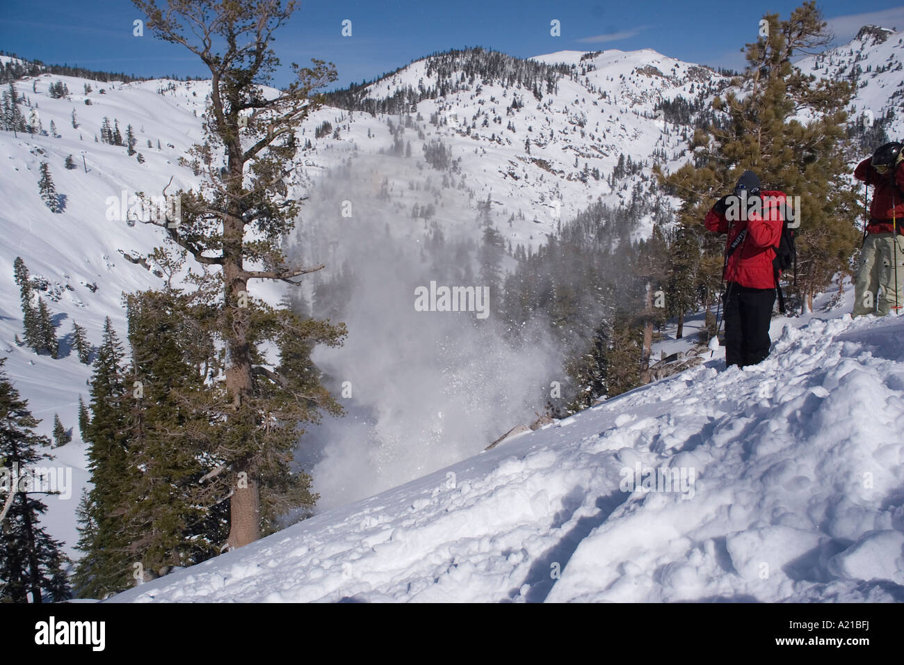 A ski patroller throwing explosives for avalanche control at Squaw ...