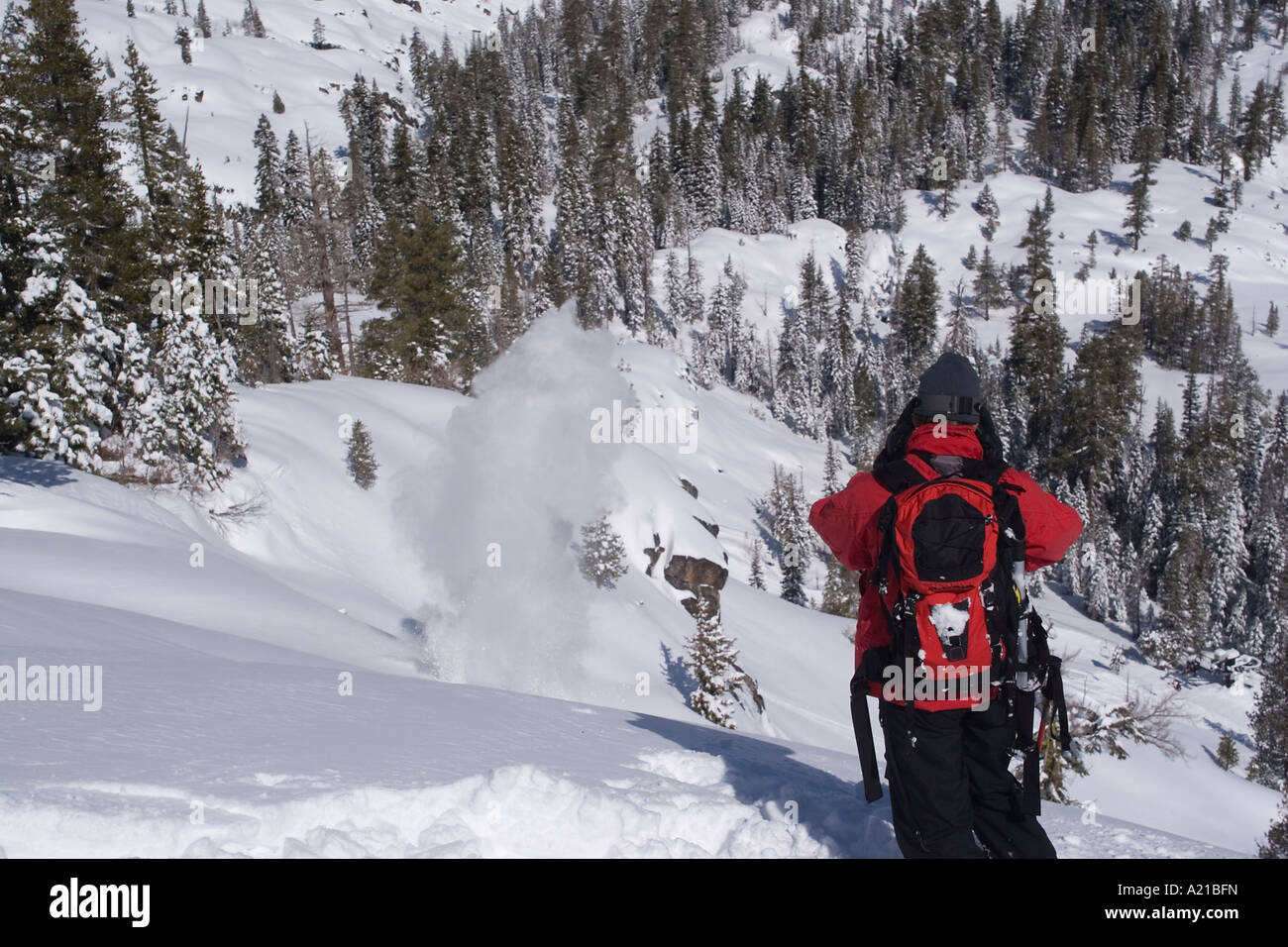 A ski patroller throwing explosives for avalanche control at Squaw ...