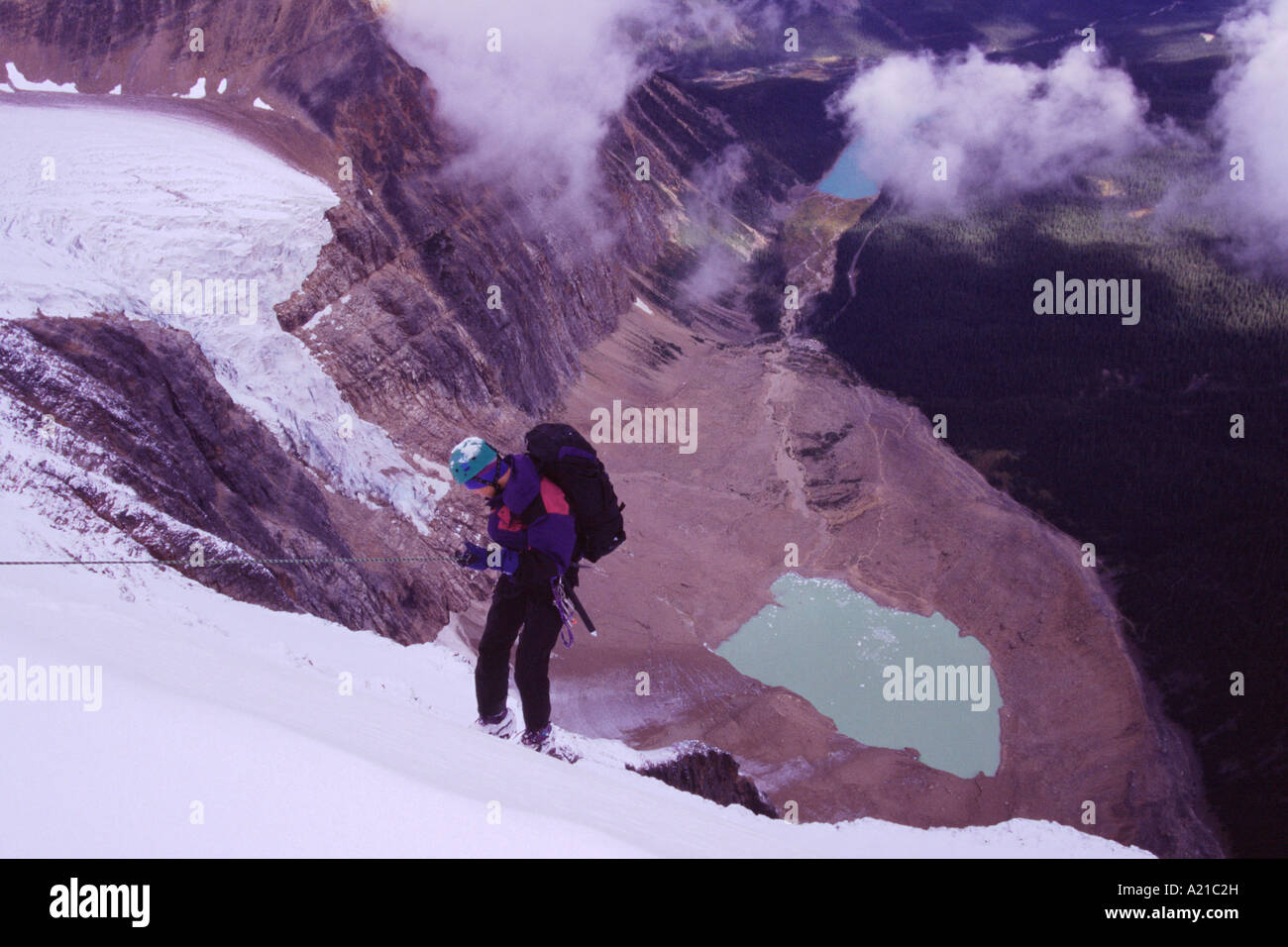 A man rappeling down a mountain in the Canadian Rockies Stock Photo - Alamy