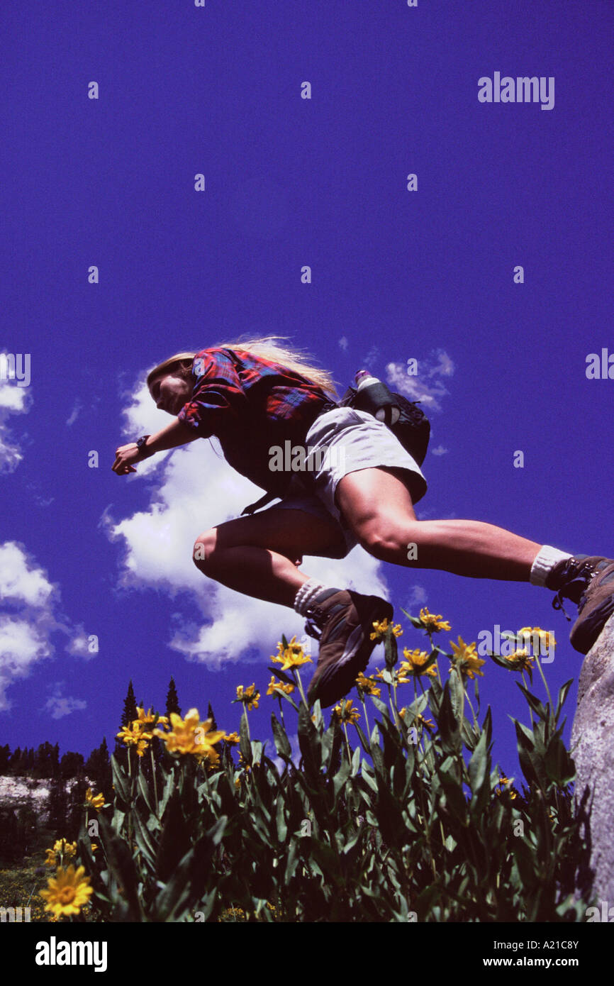 A Woman jumping over flowers in the Wasatch Mountains of Utah Stock ...
