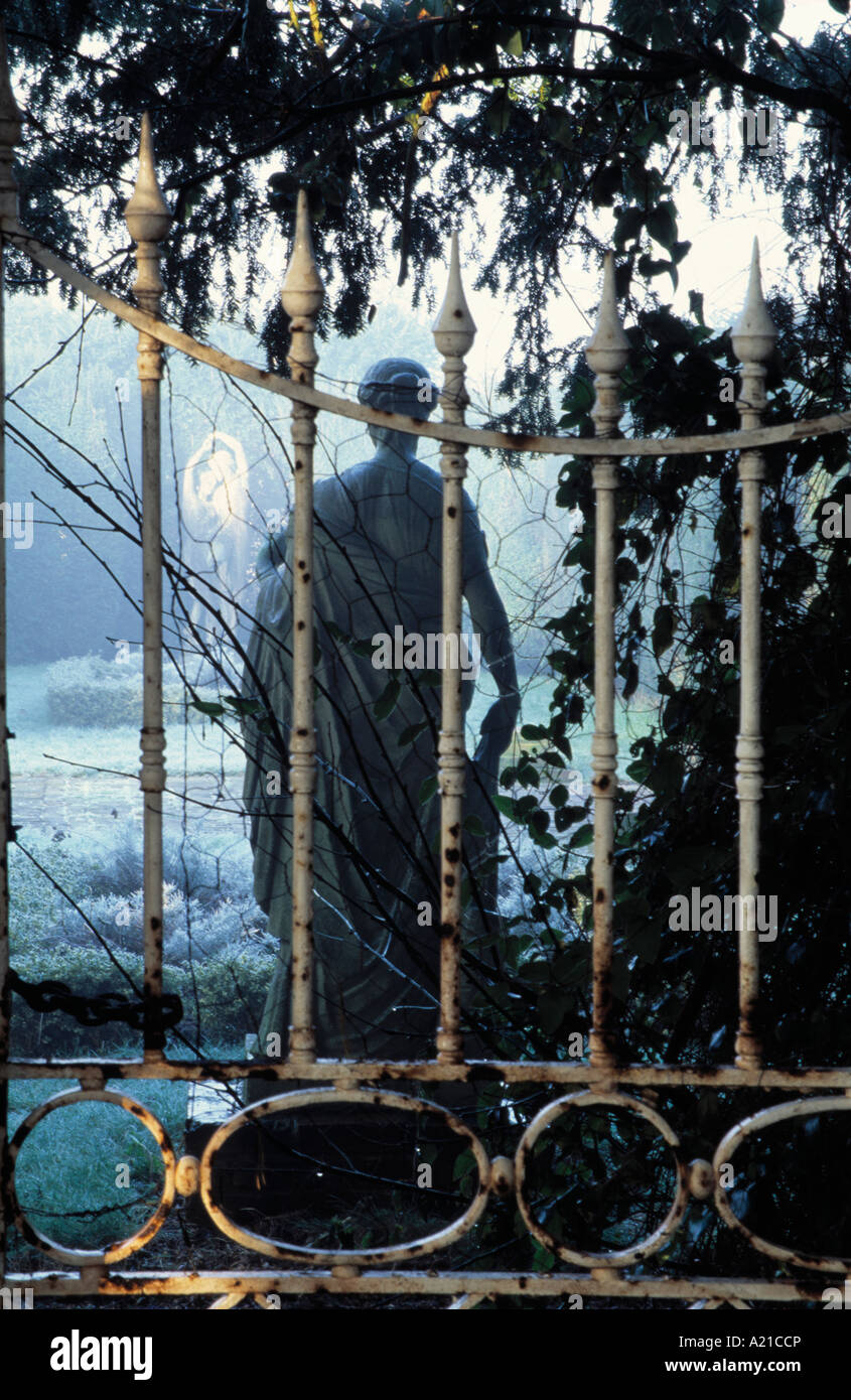 Gate with view to sculpture in winter garden Stock Photo - Alamy