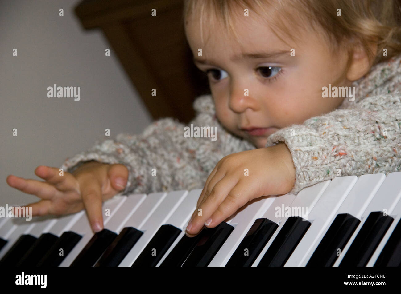 Young boy plays with a piano hi-res stock photography and images - Alamy