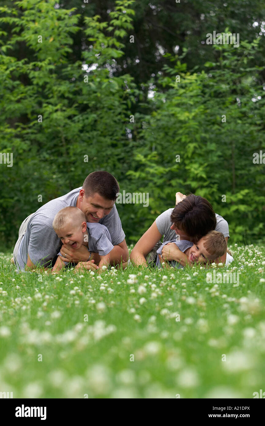 Family Playing on Grass Stock Photo - Alamy