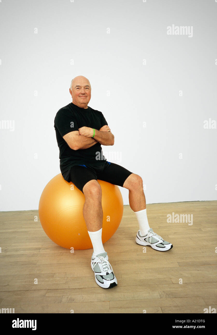 Portrait of Man Sitting on Exercise Ball Stock Photo - Alamy