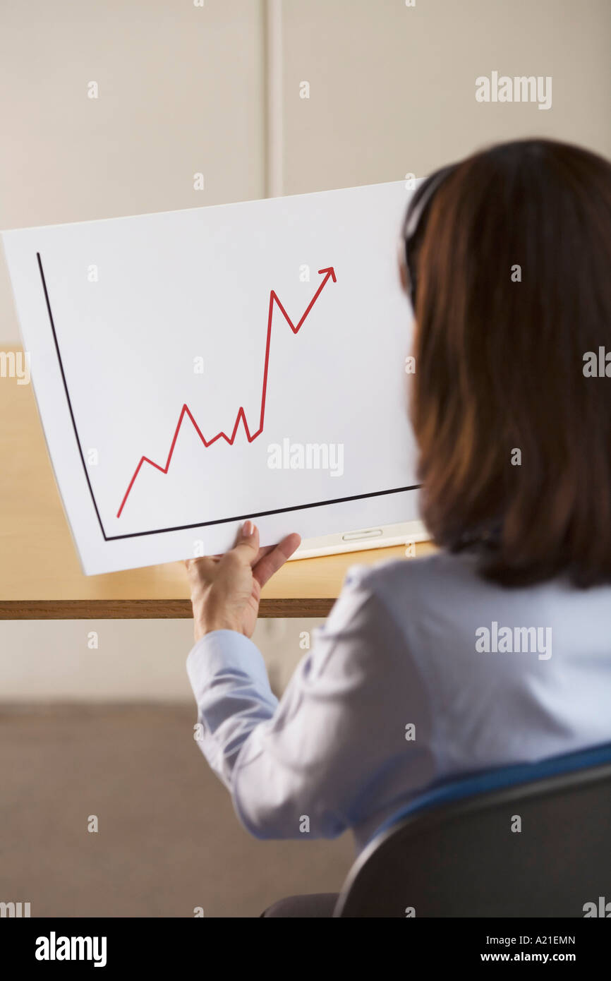 Woman Holding a Line Graph Stock Photo - Alamy