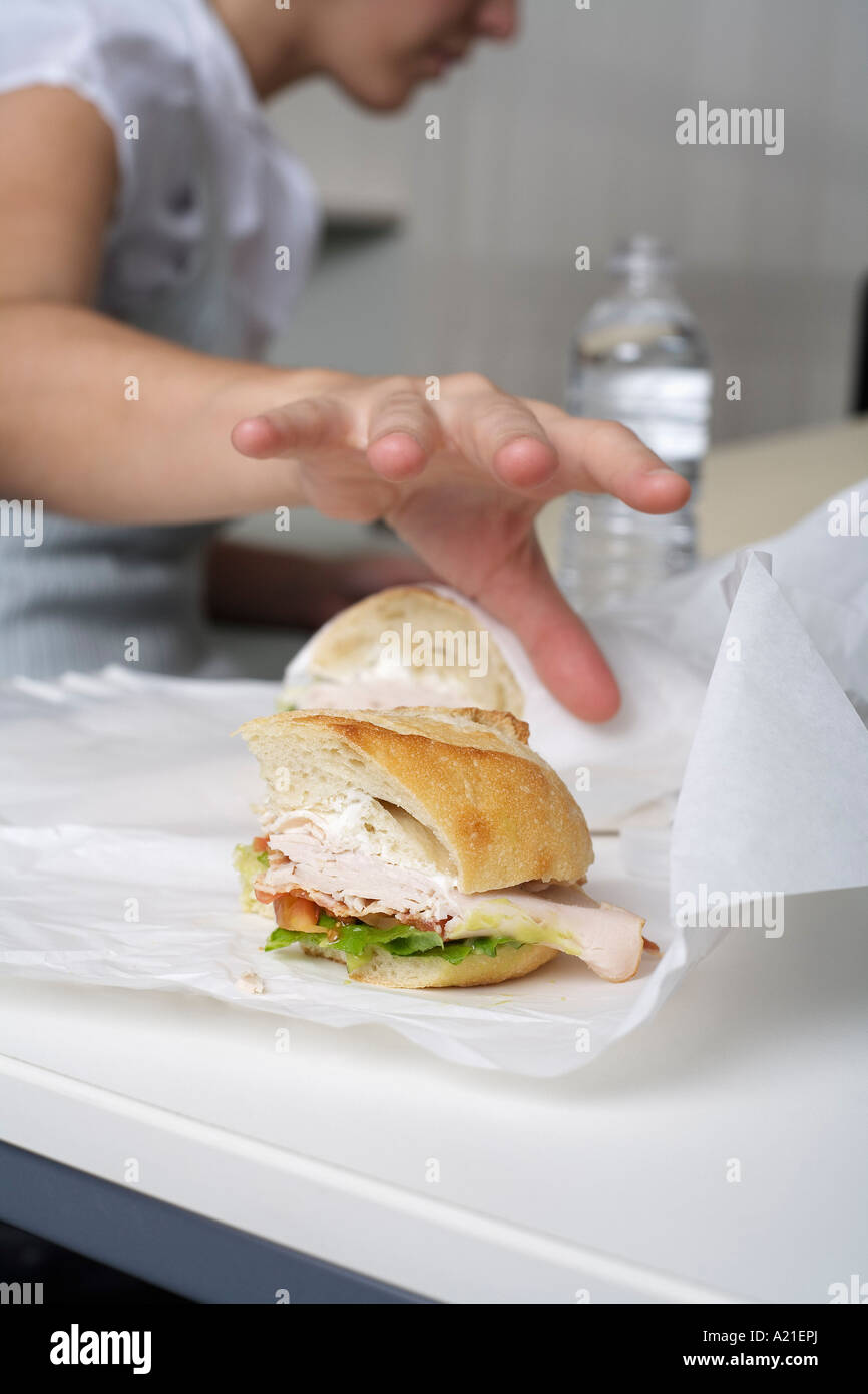 Businesswoman Eating at Desk Stock Photo - Alamy