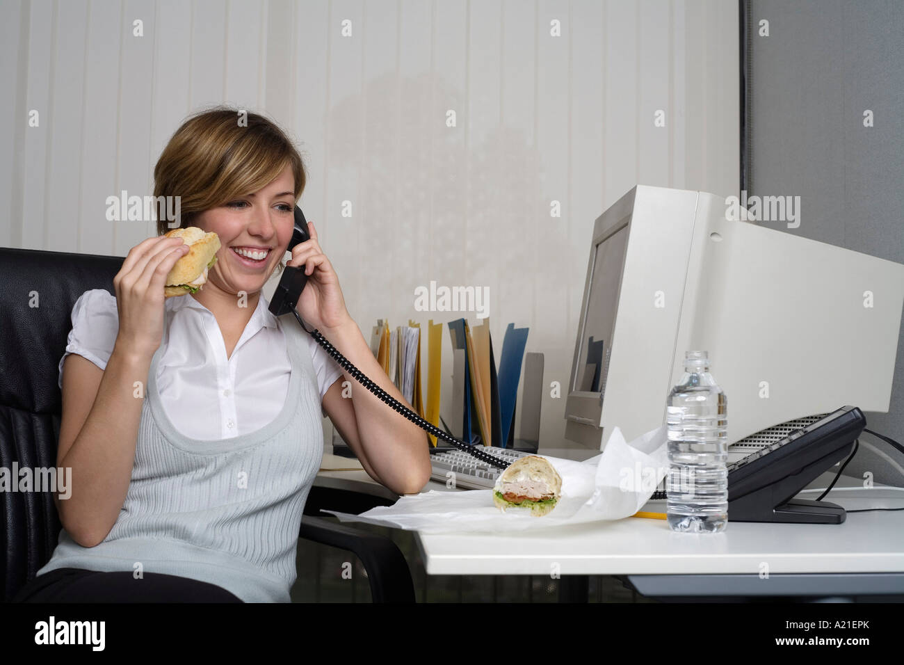 Woman alone desk computer food happy hi-res stock photography and ...