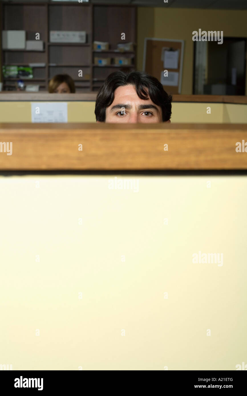 Man peeking over cubicle wall hi-res stock photography and images - Alamy
