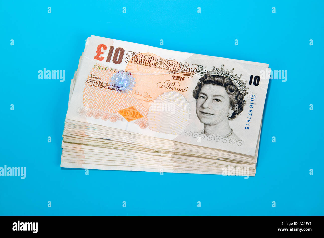 Pile of British ten 10 pound bank notes on blue Stock Photo - Alamy