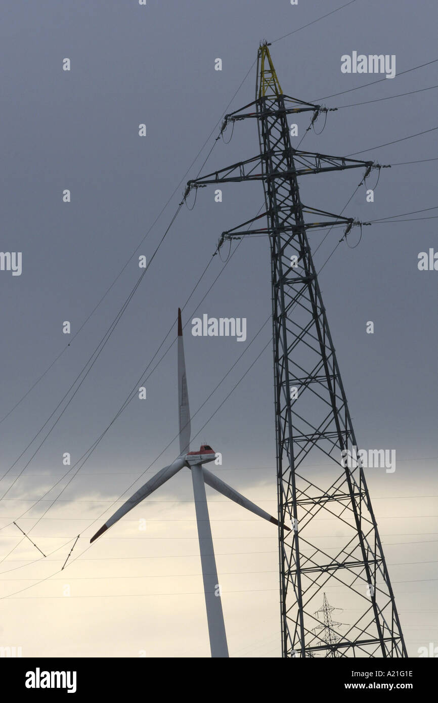 Wind power Turbines standing beside electricity pylons, Japanese ...