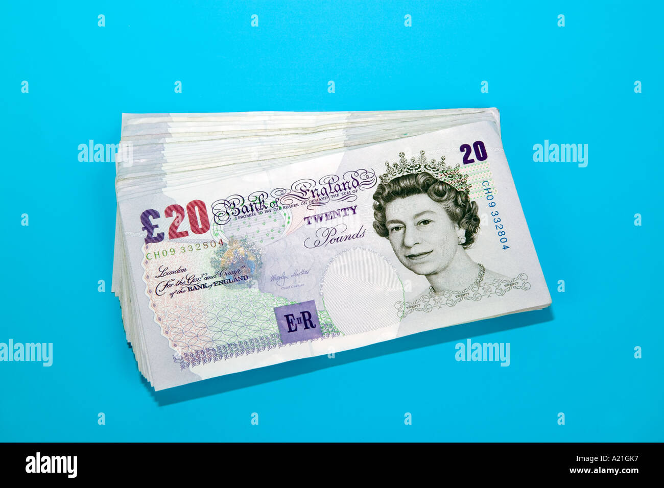 Pile of British twenty 20 pound bank notes on blue Stock Photo - Alamy