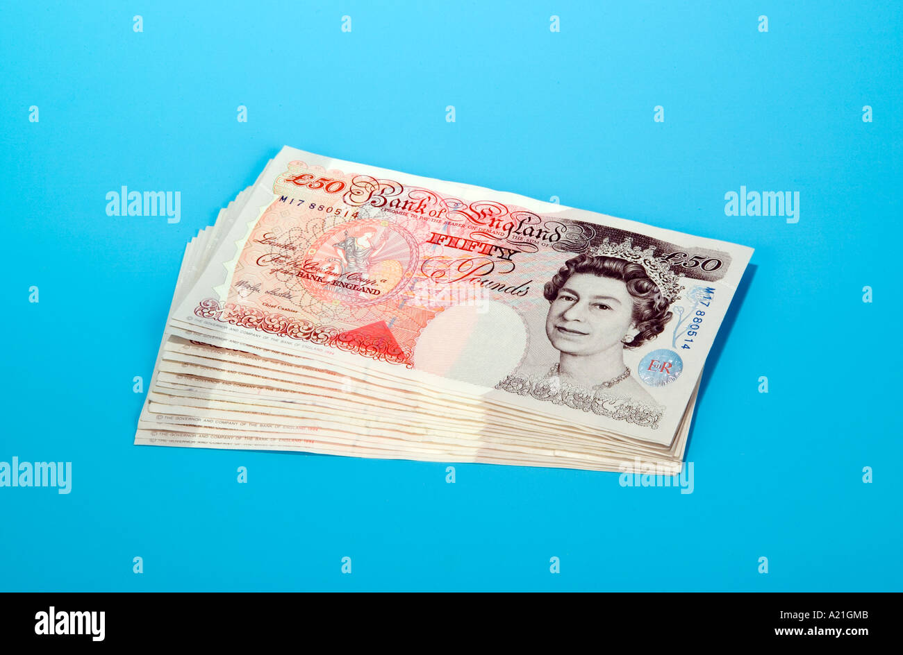 Pile of British fifty 50 pound bank notes on blue Stock Photo - Alamy