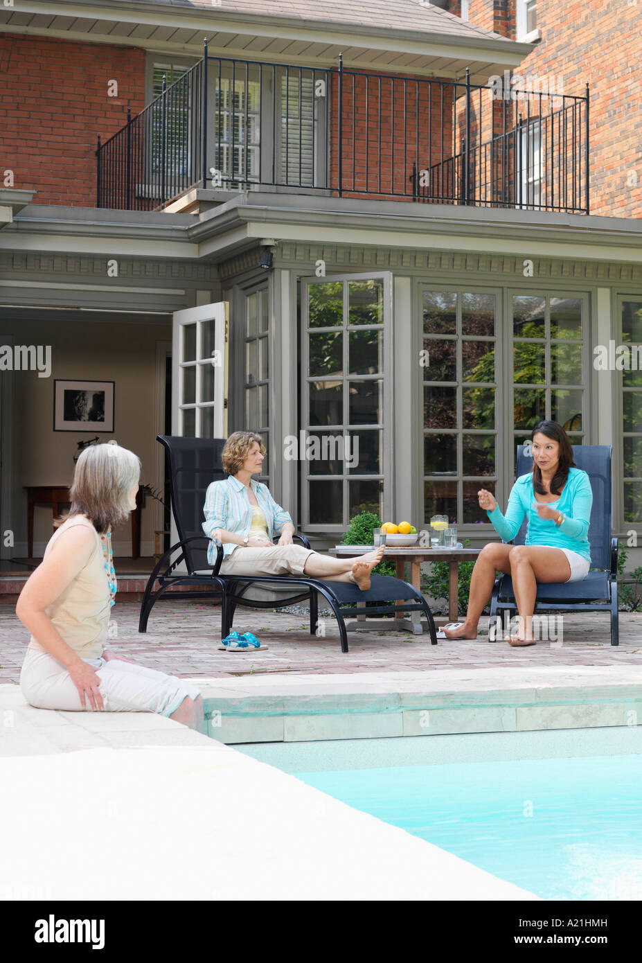 Woman lounging in chair pool hi-res stock photography and images - Alamy