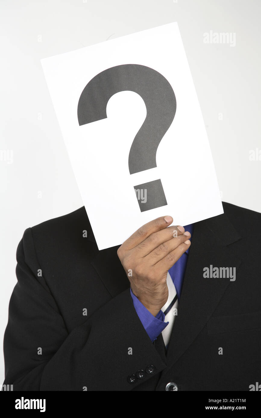 Executive holding paper question mark in front face Stock Photo - Alamy