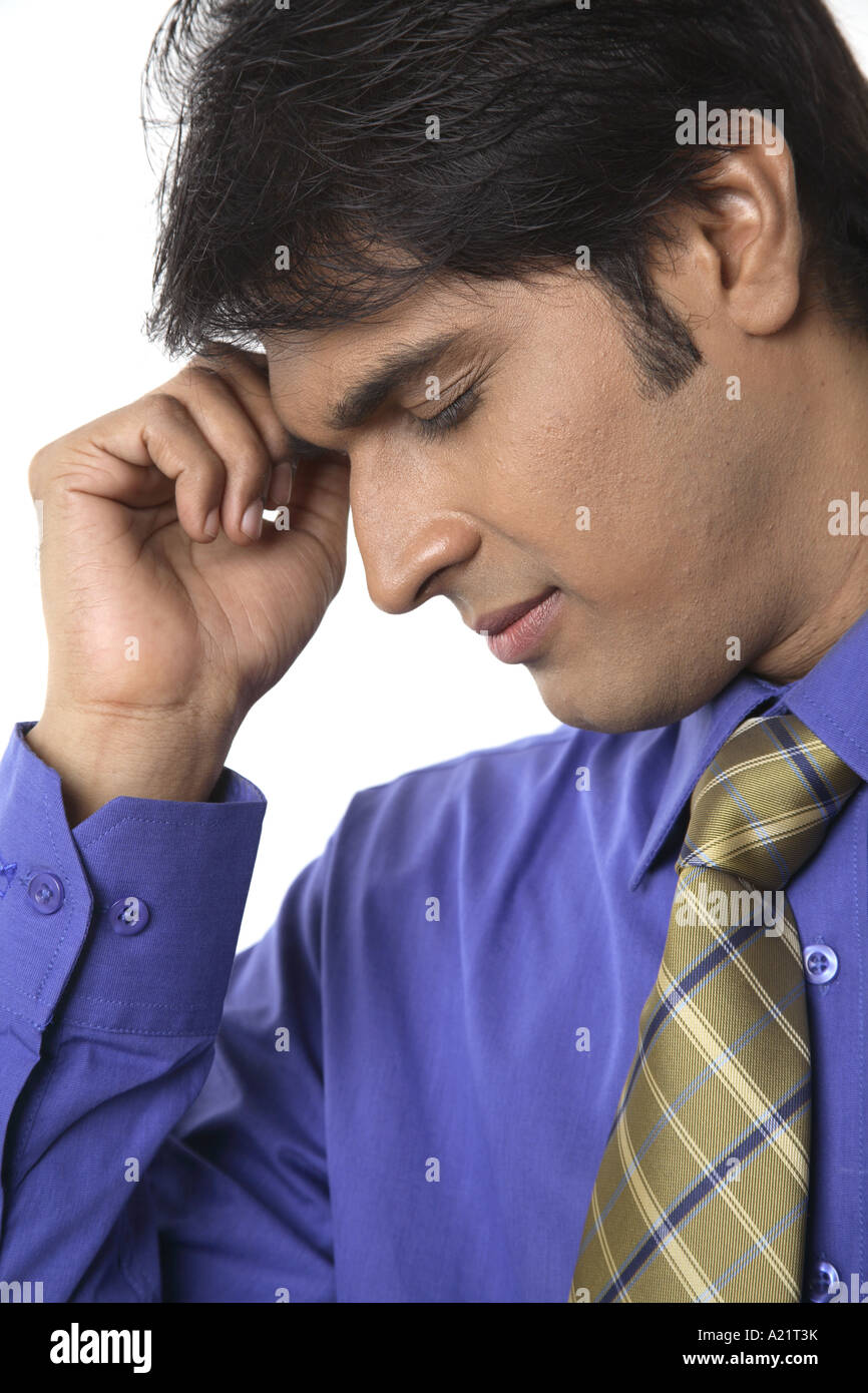 Executive touching forehead Stock Photo - Alamy