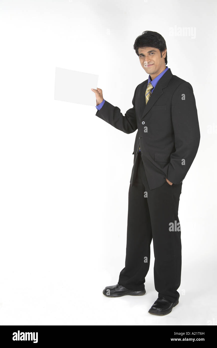 Executive with black suit standing holding paper Stock Photo - Alamy