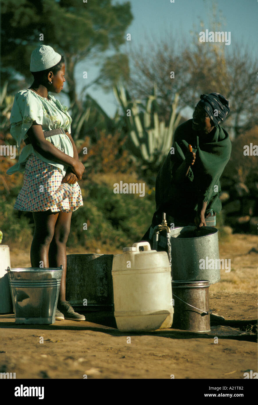 Women collecting water from the village tap, Lesotho, Southern Africa ...